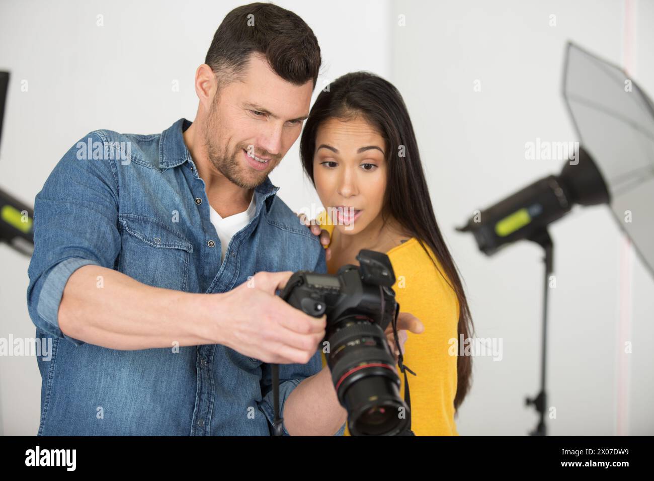 photographer and model reviewing photographs on the camera Stock Photo ...