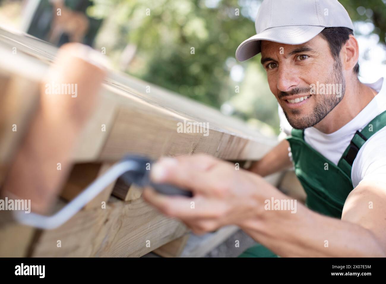 professional painter painting a bench in a park Stock Photo - Alamy