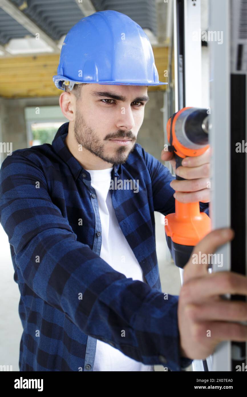 Worker drills hole in metal hi-res stock photography and images - Alamy