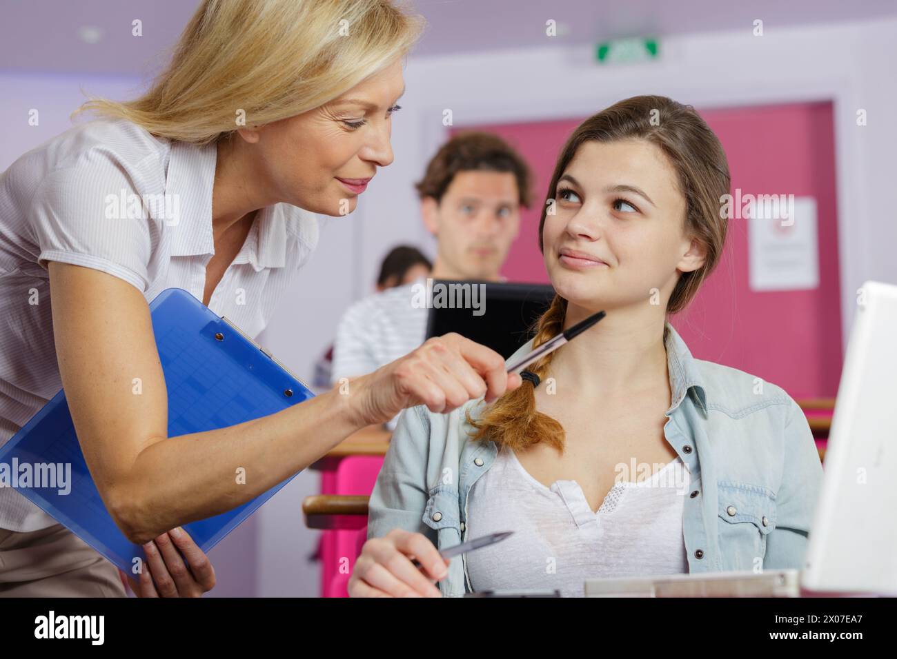 professor looking at female student Stock Photo - Alamy