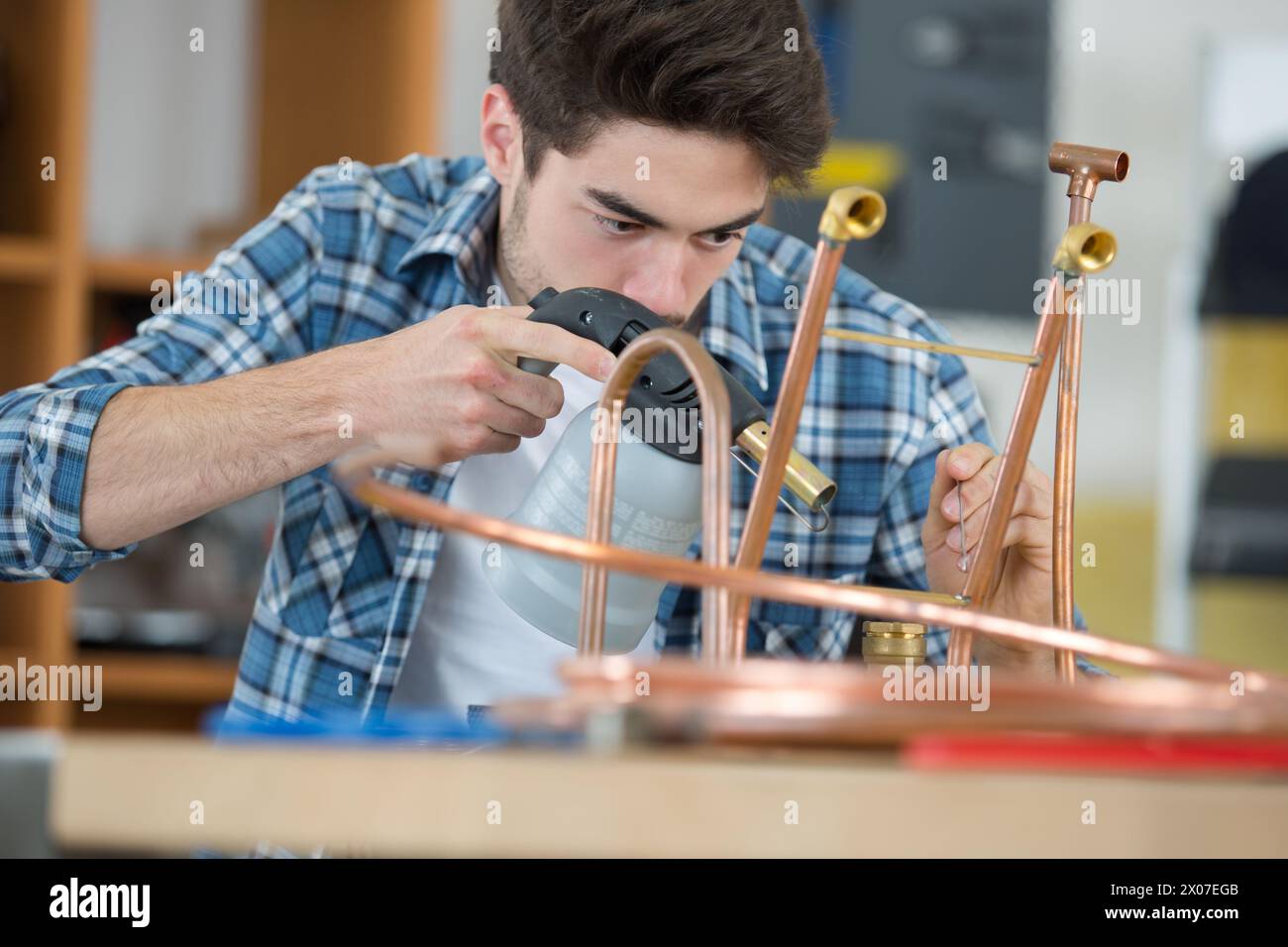 Worker using blowtorch soldering hi-res stock photography and images ...