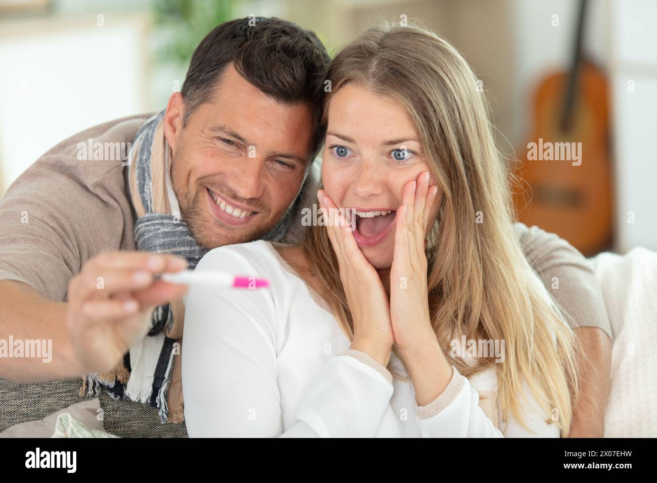 happy couple checking pregnancy test Stock Photo - Alamy
