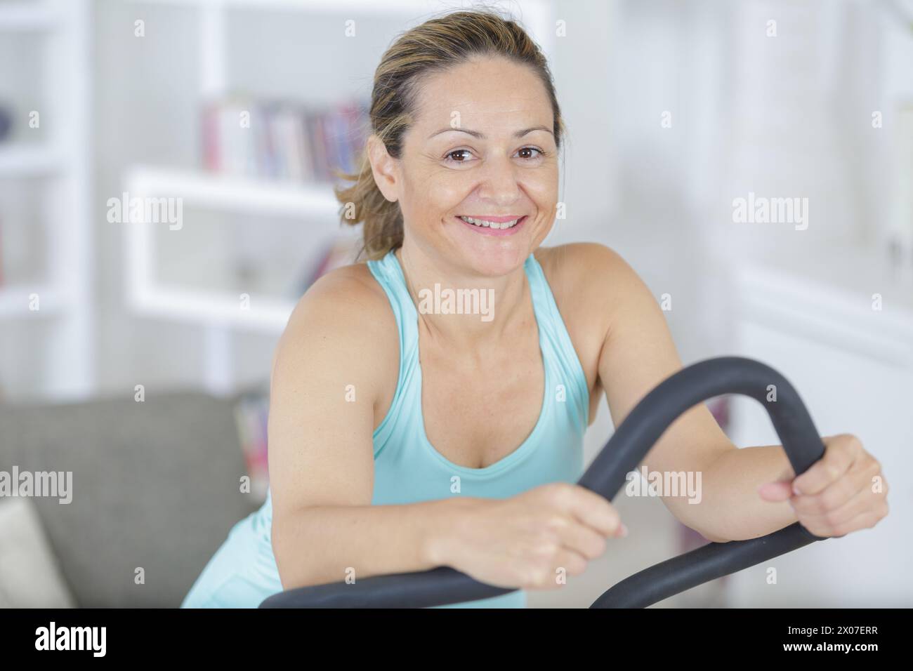 mature woman exercising on step machine Stock Photo - Alamy