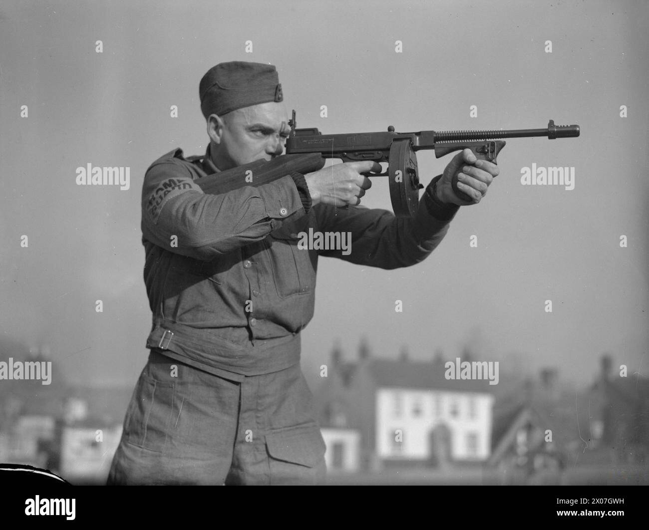 THE HOME GUARD, 1940 - A Home Guard takes aim with a Thompson ...
