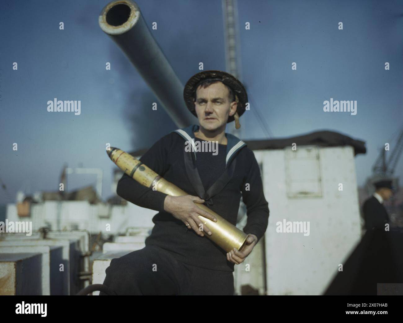 THE ROYAL NAVY, NOVEMBER 1943 - A naval gunner holding a shell Royal ...