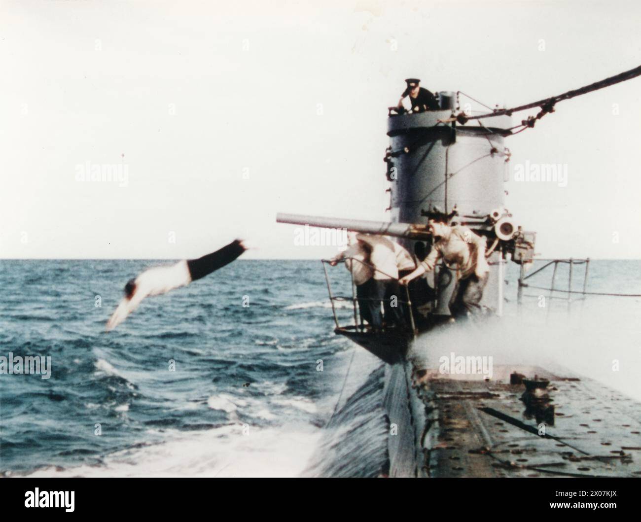 A crewman is shown diving from a surfaced U-boat in the Western ...
