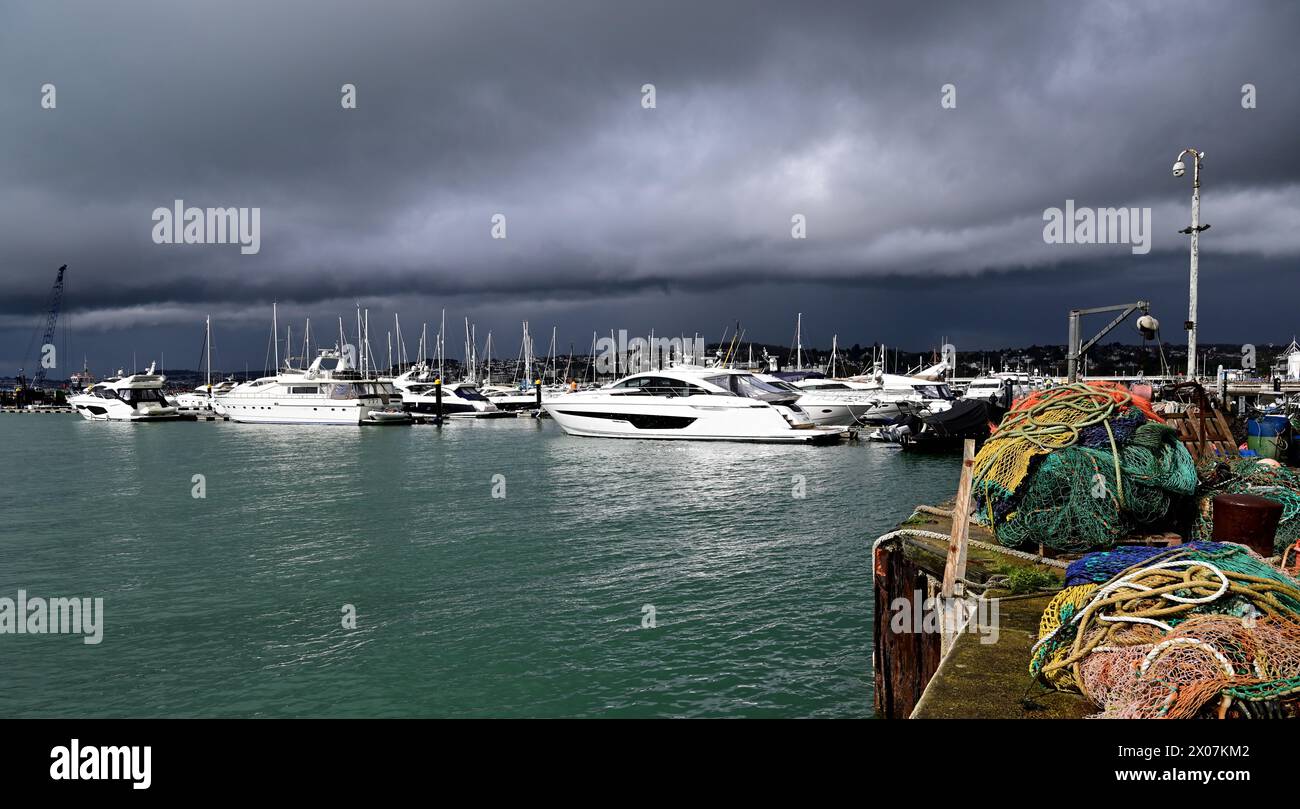 Sunshine and dark clouds over boats in Torquay harbour, as rain ...