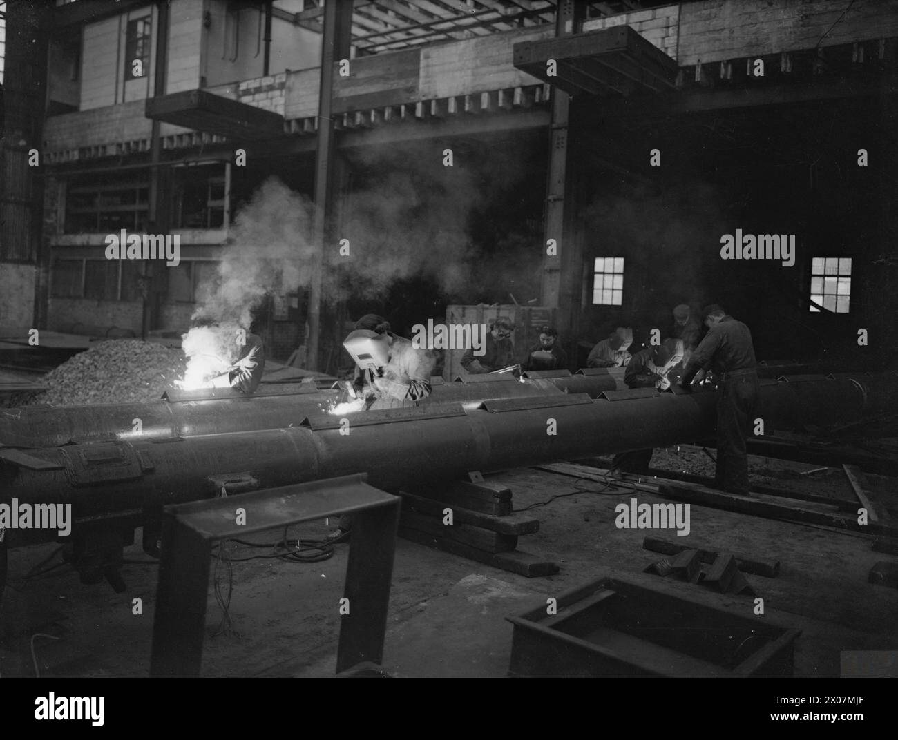 On 6 October 1942, at Greenock, workers welded steel masts of a ...