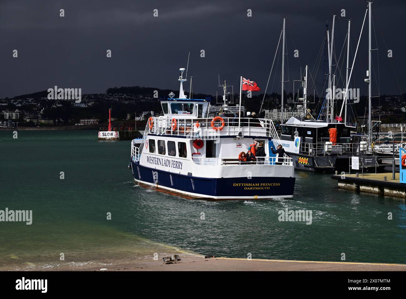 Sunshine and dark clouds over boats in Torquay harbour, as rain ...