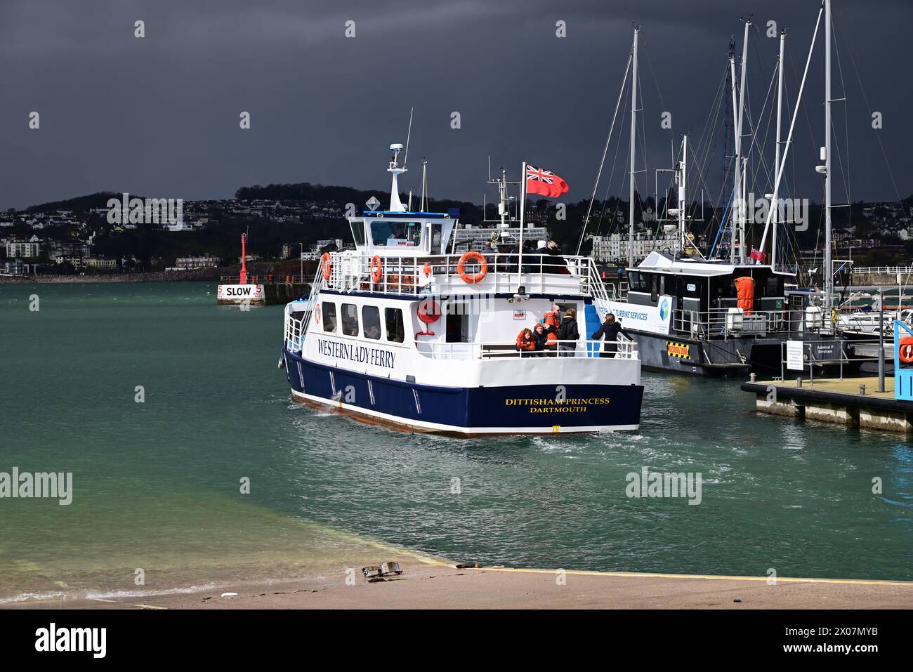 Sunshine and dark clouds over boats in Torquay harbour, as rain ...
