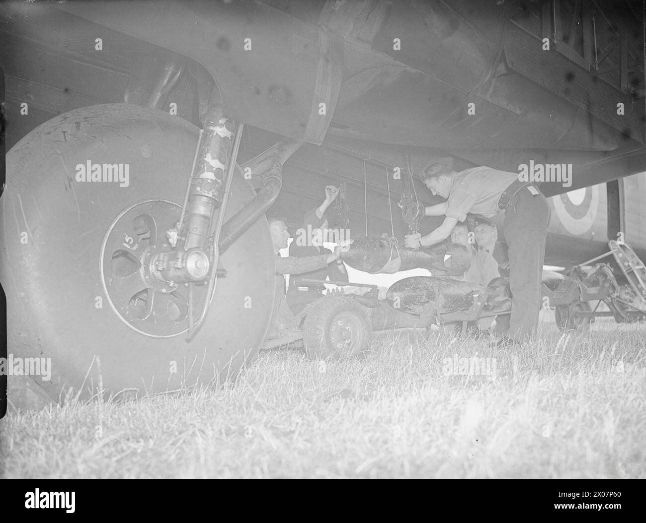 ROYAL AIR FORCE BOMBER COMMAND, 1939-1941. - Armourers load an Armstrong Whitworth Whitley with ...