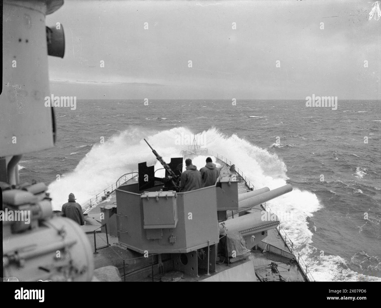A 20 mm Oerlikon anti-aircraft gun crew operates at action stations ...