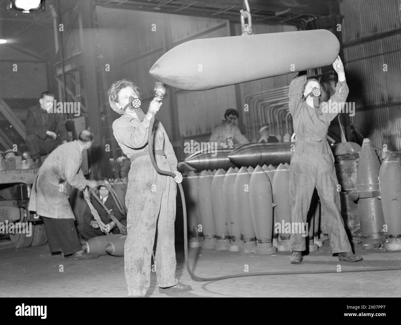 Two women in a Yorkshire shell factory spray paint bombs wearing masks ...