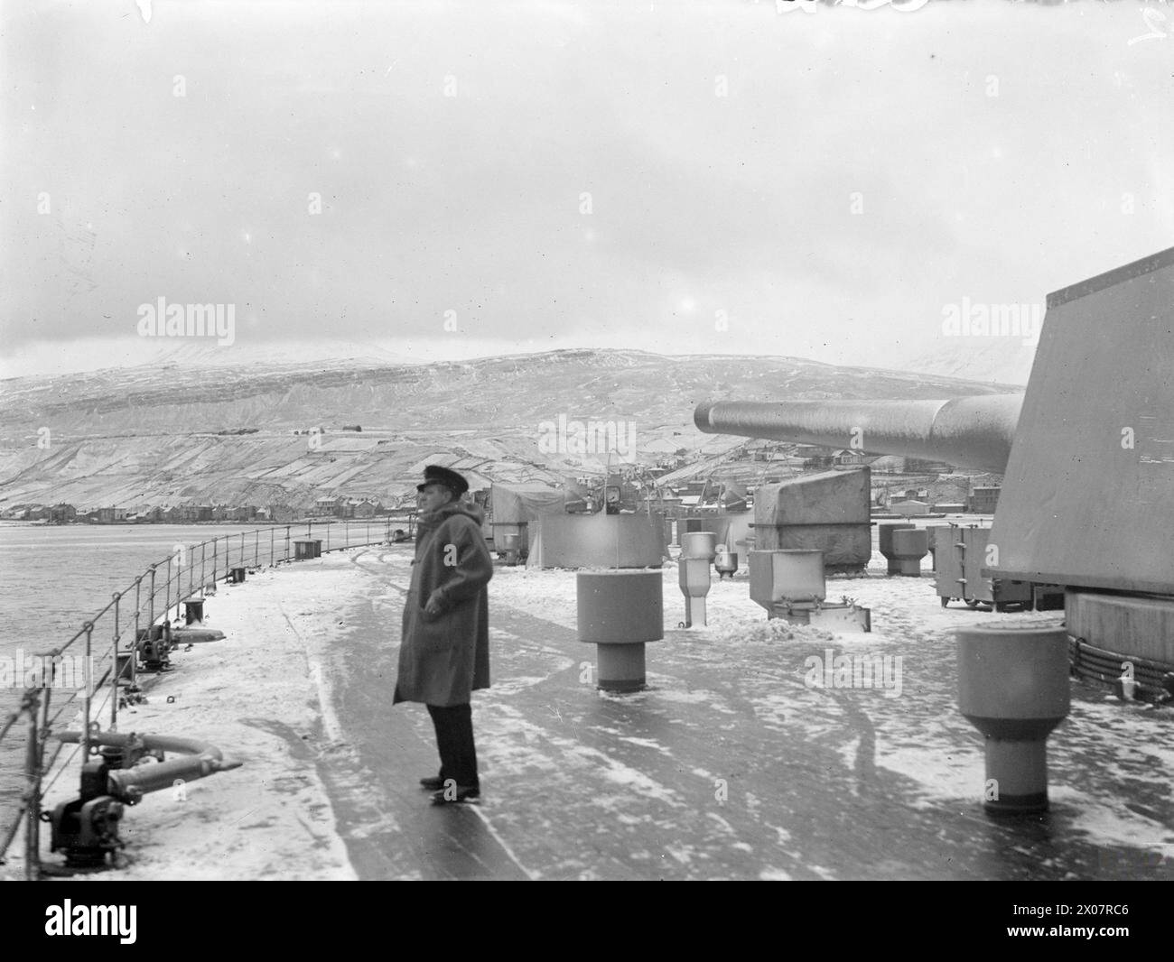 In December 1943, HMS Duke of York is pictured in an Icelandic fjord ...
