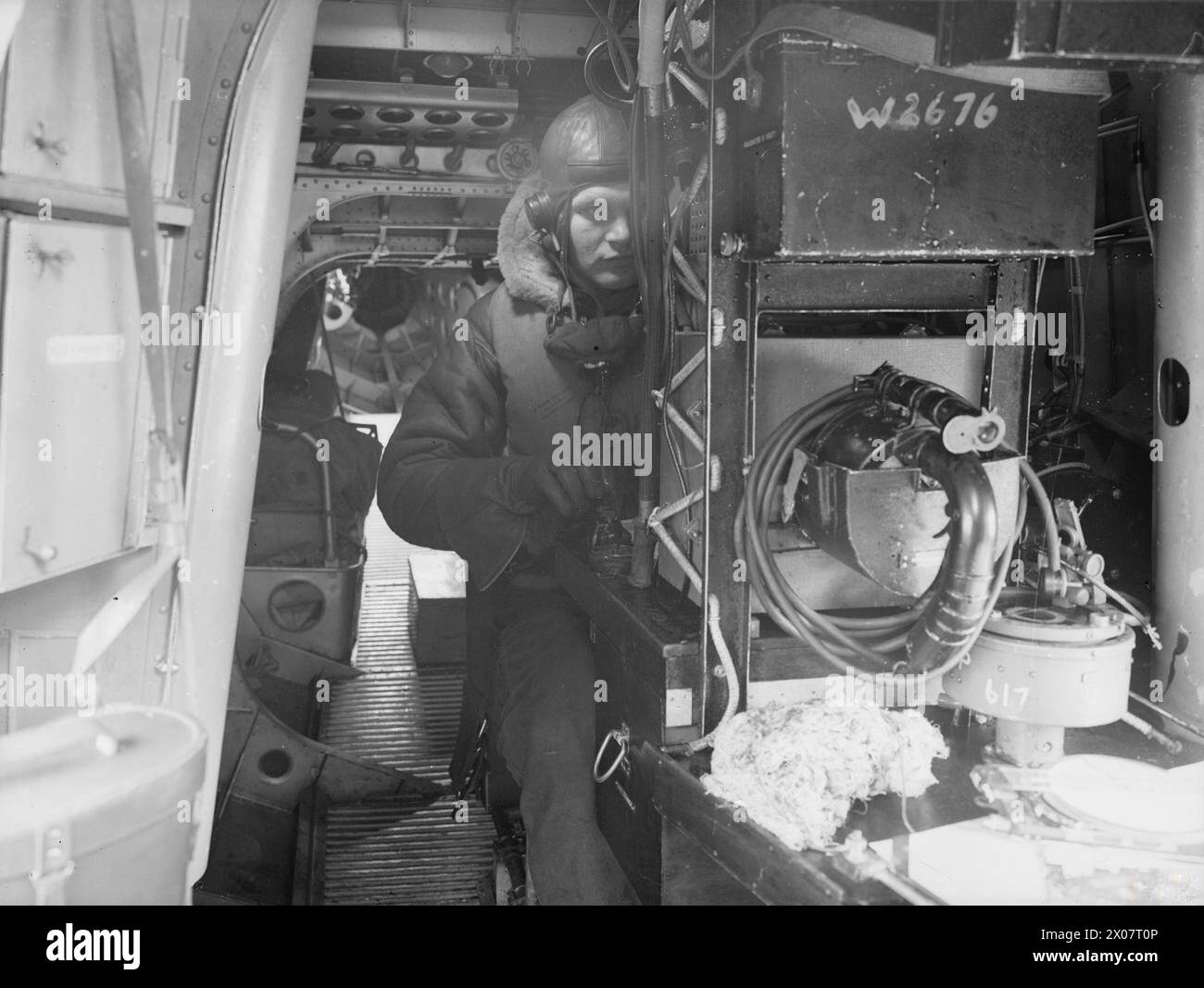 An air gunner and wireless operator on HMS Suffolk operates the radio ...