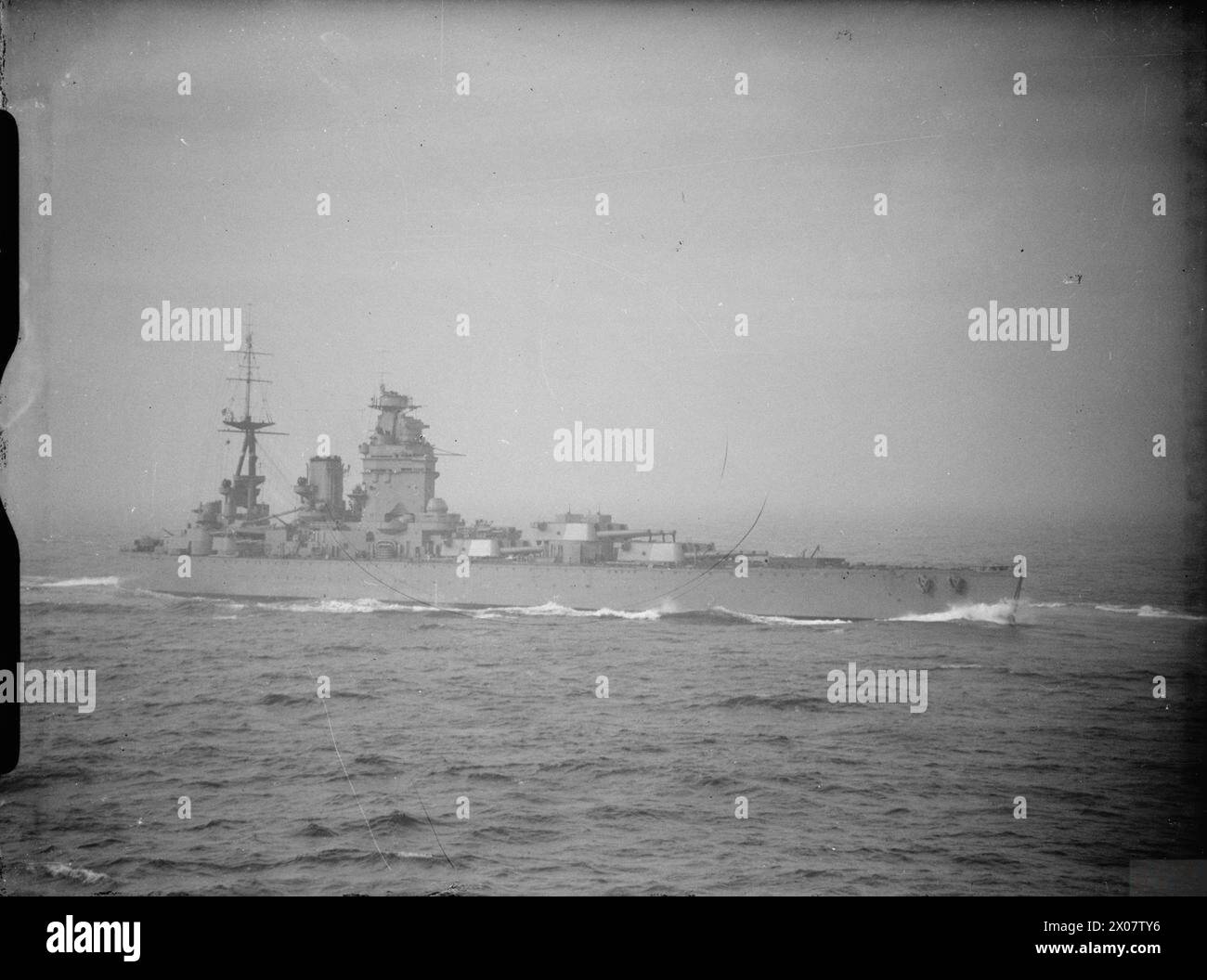 HMS Rodney performs a turning maneuver with other fleet units during a ...