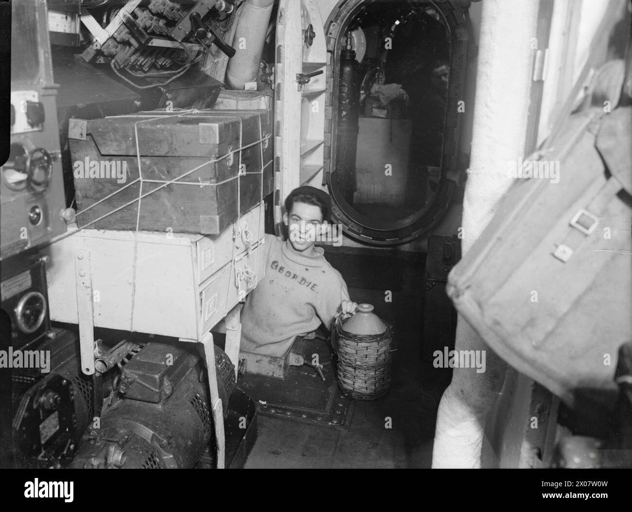 G R Gill of Durham retrieves a rum jar from the hatchway of HMS Seraph ...