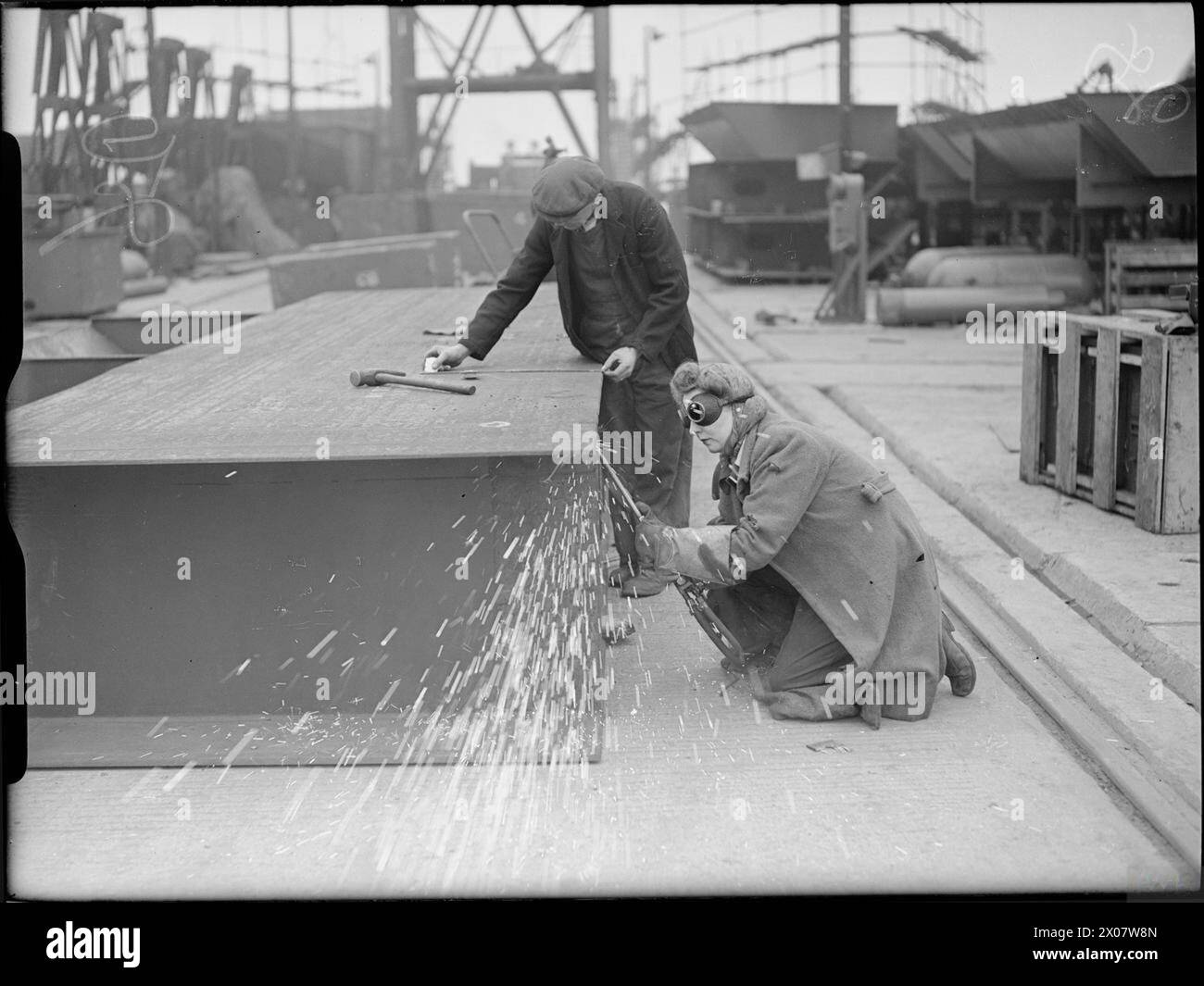 THE ROYAL NAVY DURING THE SECOND WORLD WAR - A girl "burner" takes off the edge of a bulkhead ...