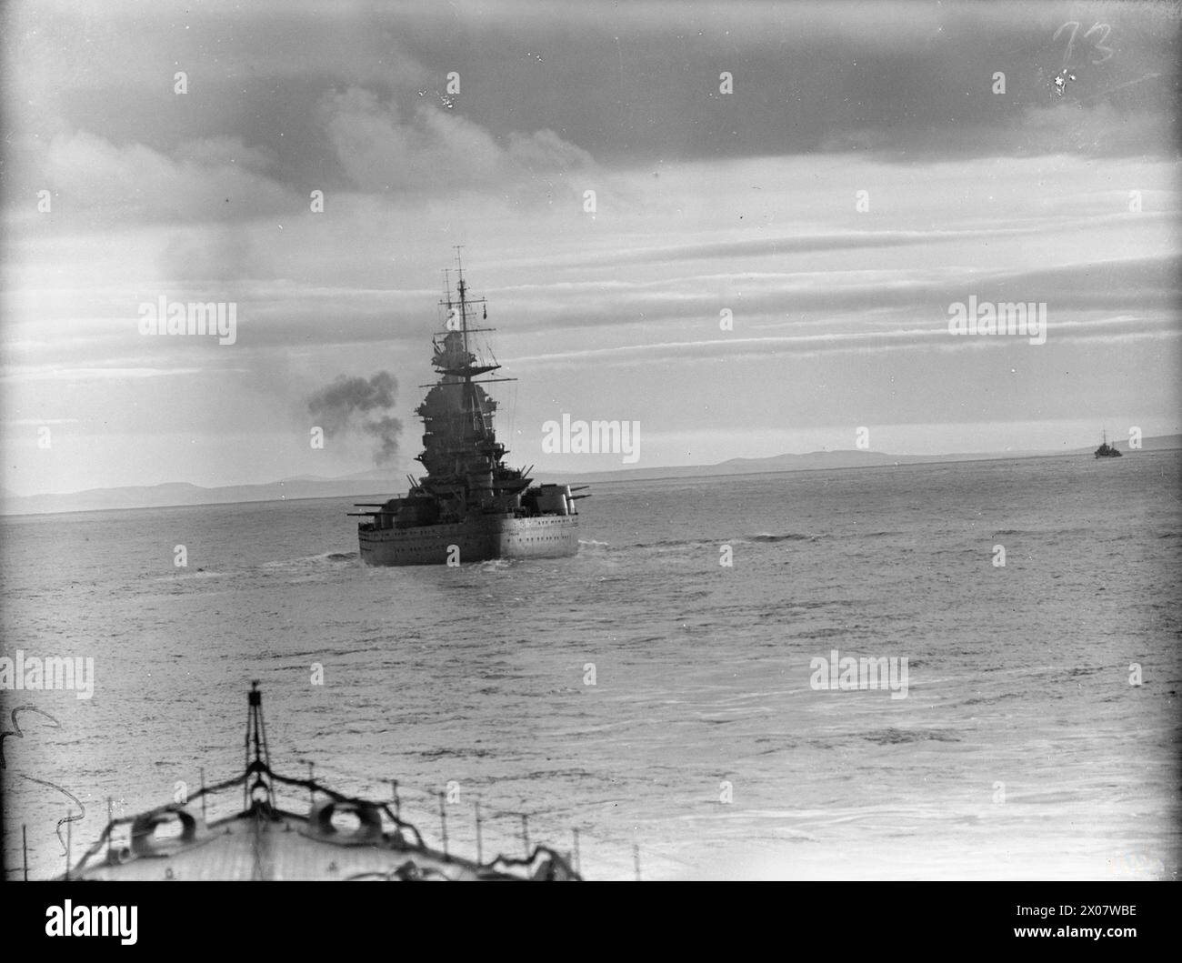 ON BOARD THE BATTLESHIP HMS RODNEY AT SEA. 1940. - HMS NELSON firing ...