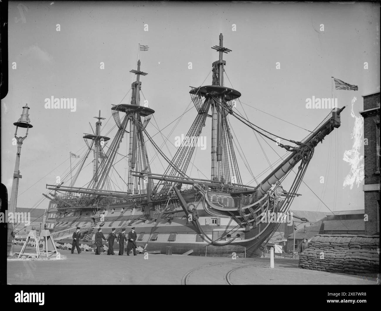 Candidates for commission in the RNVR stand alongside HMS Victory at ...