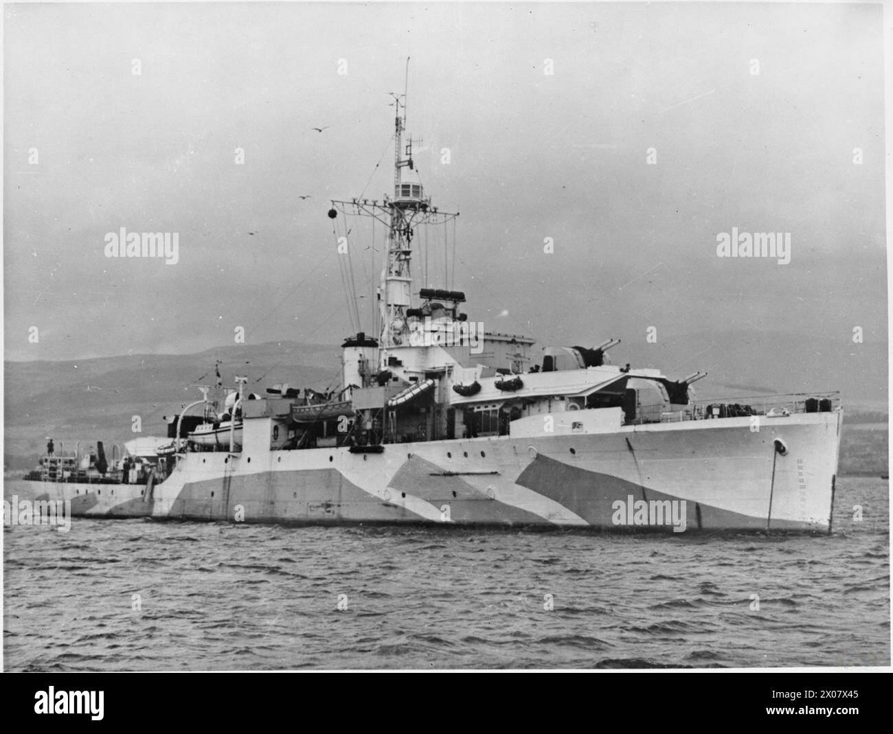 HMS Amethyst is at anchor during Royal Navy operations in WWII; the ...