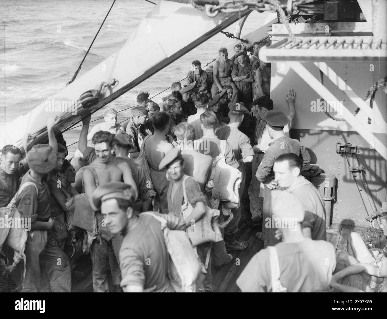 Troops of the Highland Division aboard HMS Princess Beatrix listen to ...