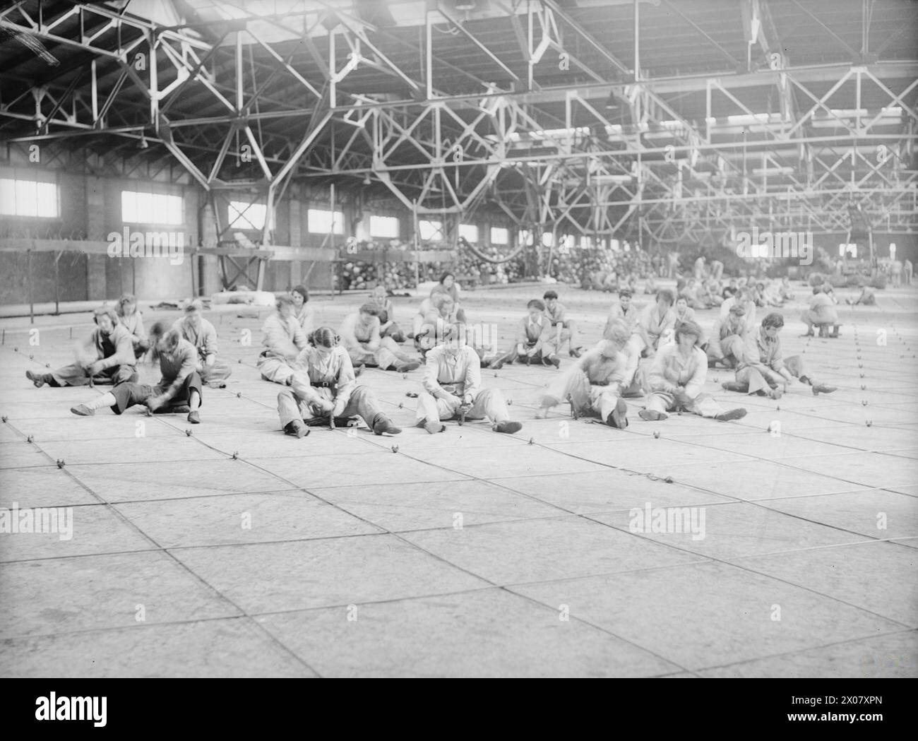Women are constructing boom defence nets on a slab in Southampton on 13 ...