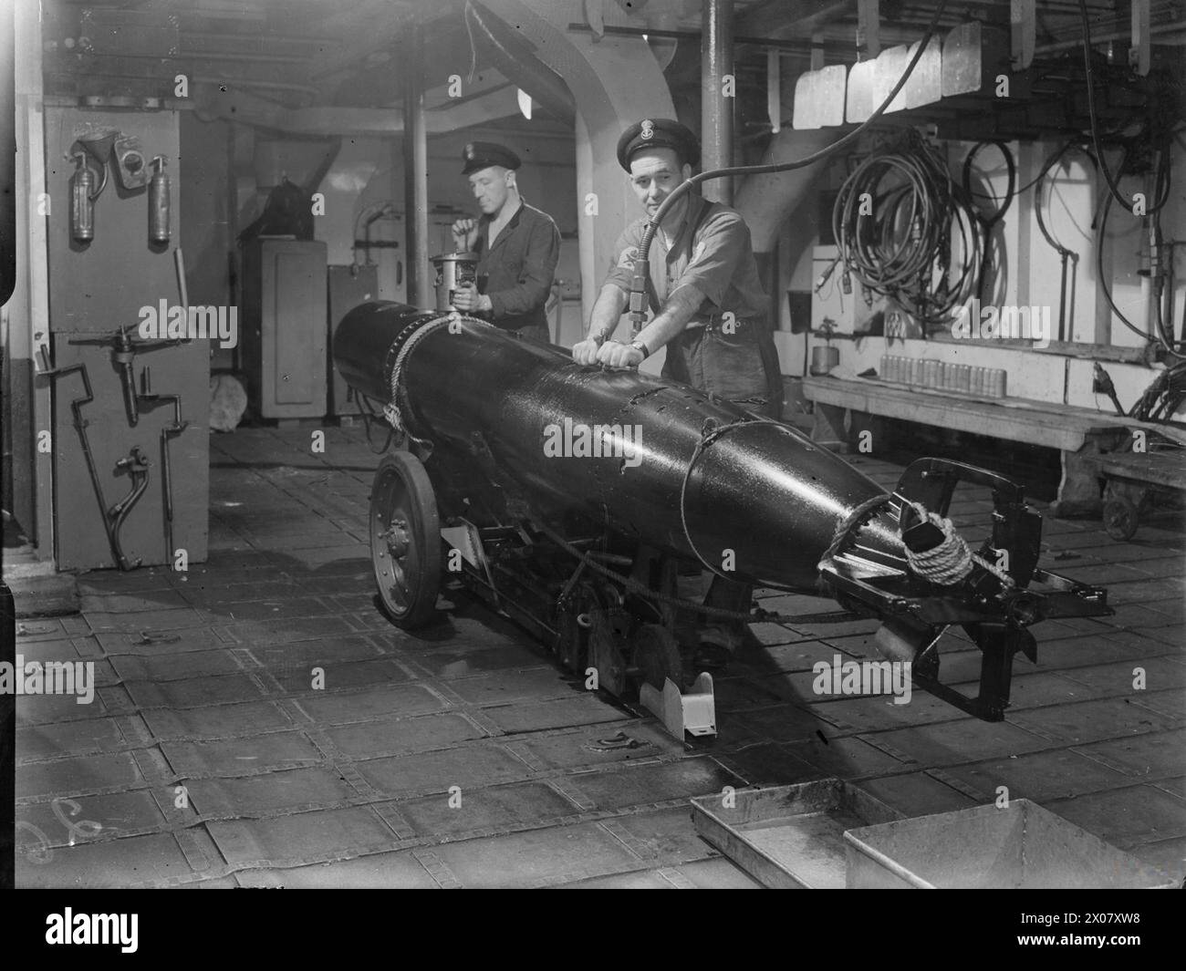 THE ROYAL NAVY DURING THE SECOND WORLD WAR - Mechanics at work on an 18 inch torpedo in one of ...