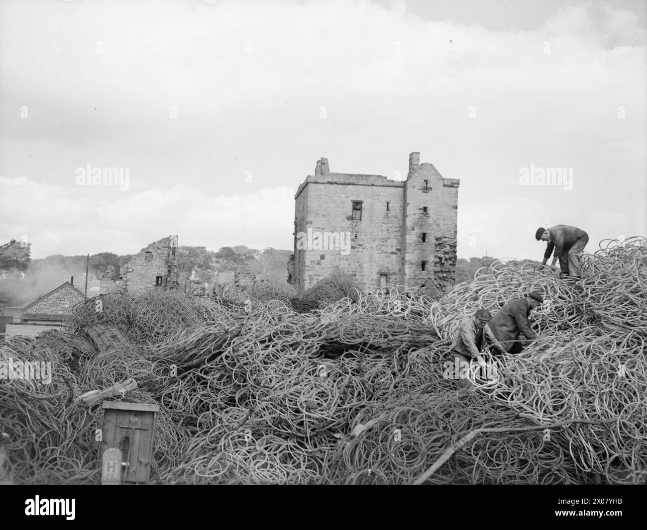 On 11 August 1944, at Rosyth Royal Naval Dockyard, a dockyard worker is ...