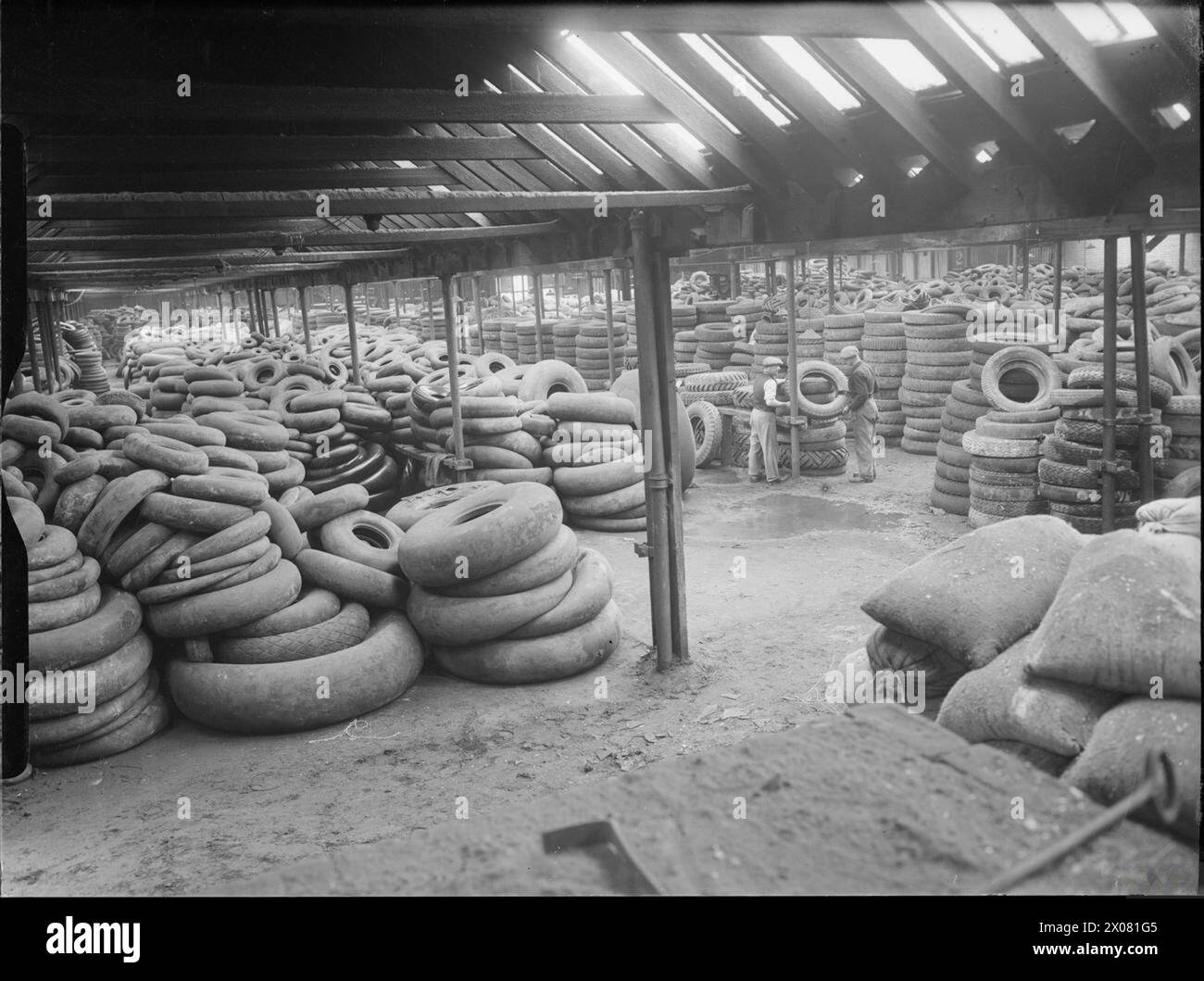 RUBBER SALVAGE ON THE BRITISH HOME FRONT, 1942 - Stacks of rubber tyres ...