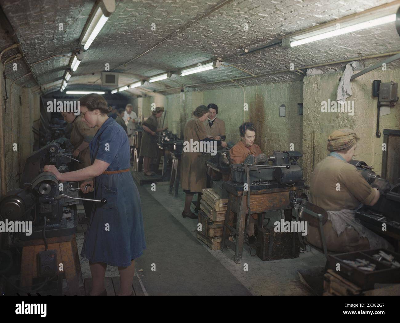 Women working on 20mm cannon shells and .303 rifle bullets in an ...