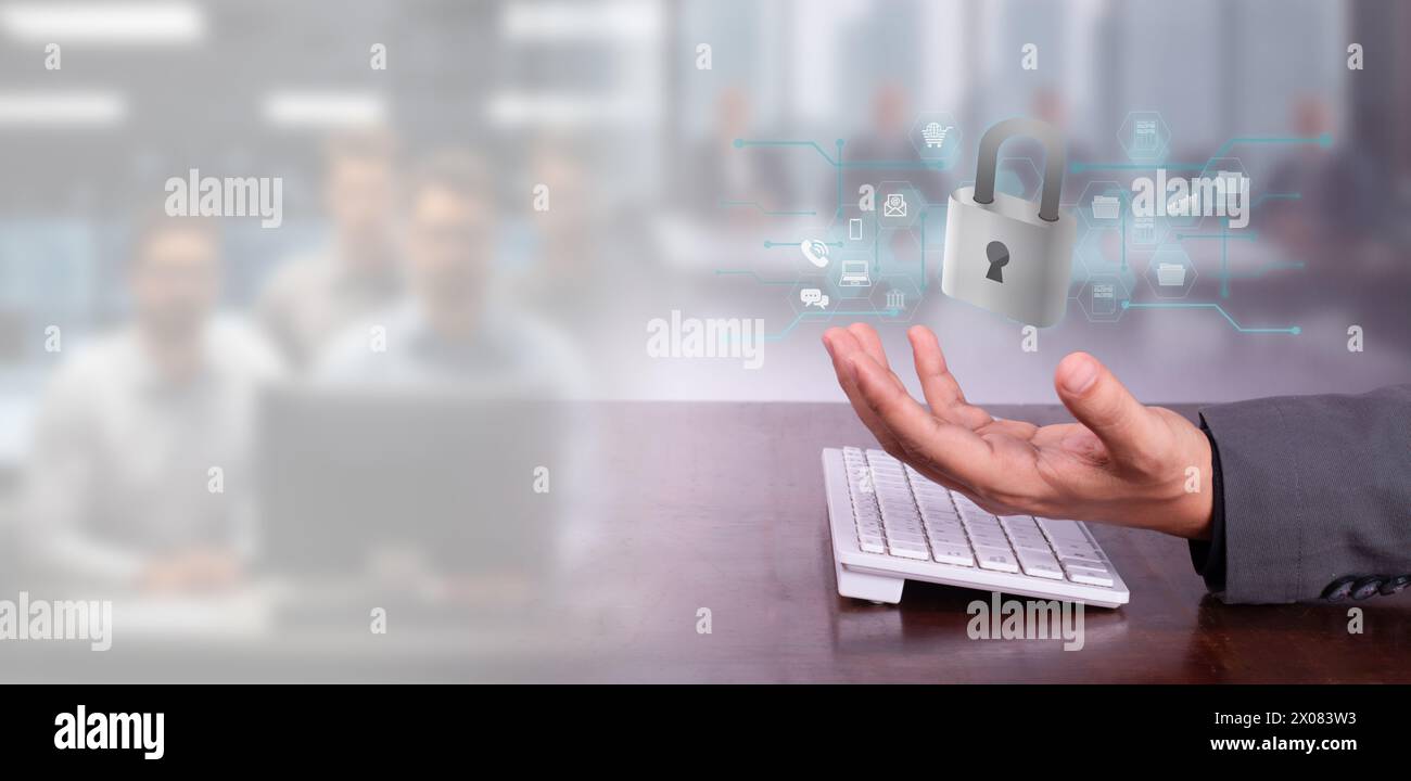 cybersecurity concept: businessman at his desk holds hologram of padlock with security icons ...