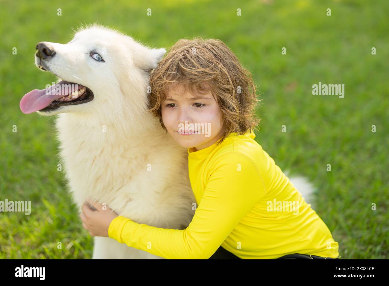 Blonde Kid and dog outdoor portrait. Kids friend. Kid hugging dog in ...