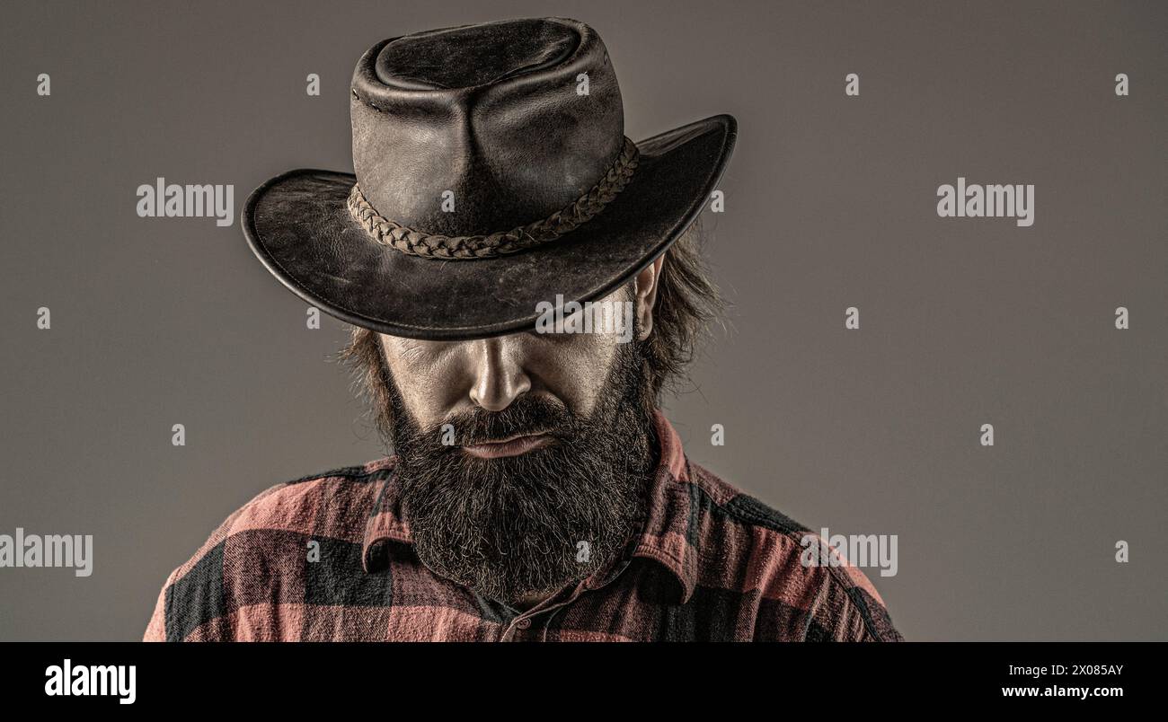 Cowboy style. Handsome young man adjusting his cowboy hat. Cowboys in ...