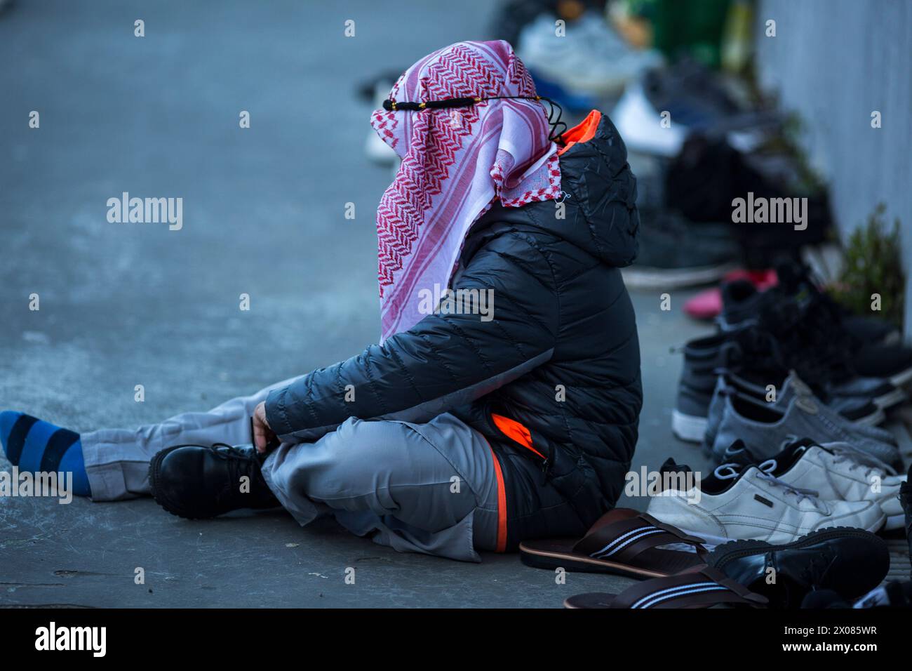 Madrid, Spain. 10th Apr, 2024. A young Muslim boy takes off his shoes ...