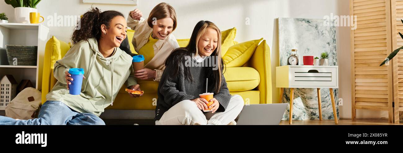 A diverse group of teenage girls are lounging happily on a yellow couch ...