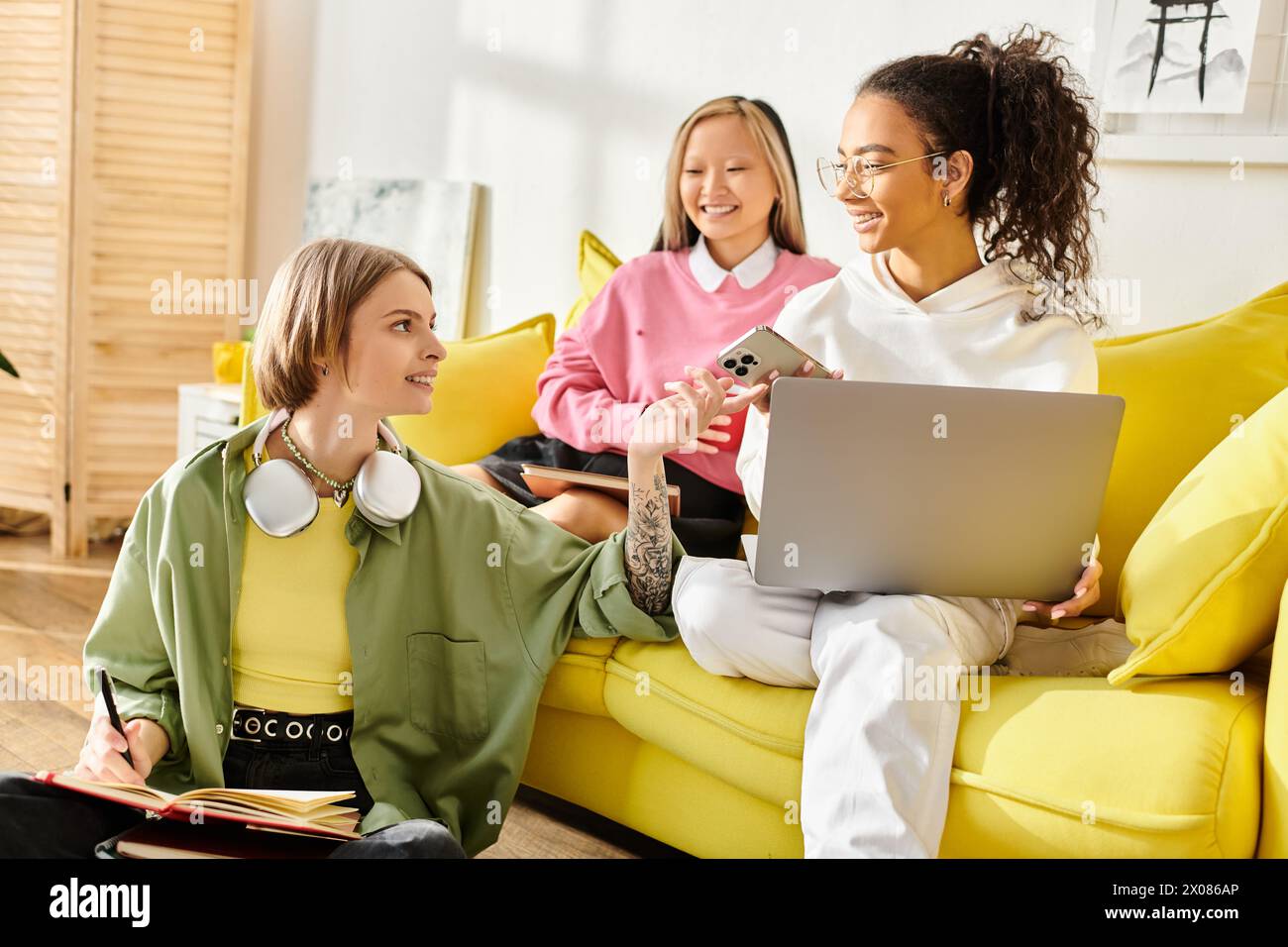 A diverse group of teenage girls engaging in a study session on a ...