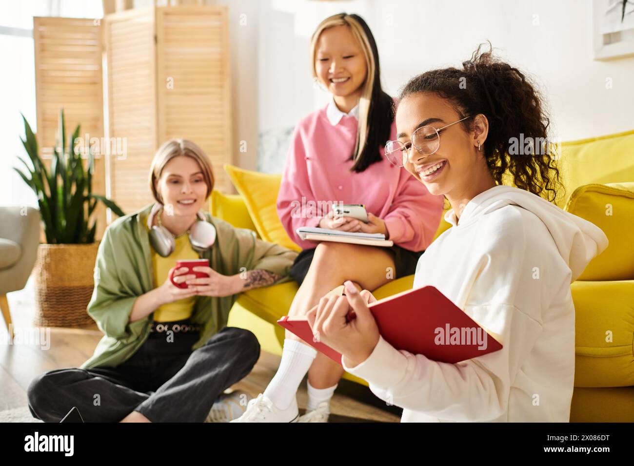 Diverse group of teenage girls sitting comfortably on a bright yellow ...
