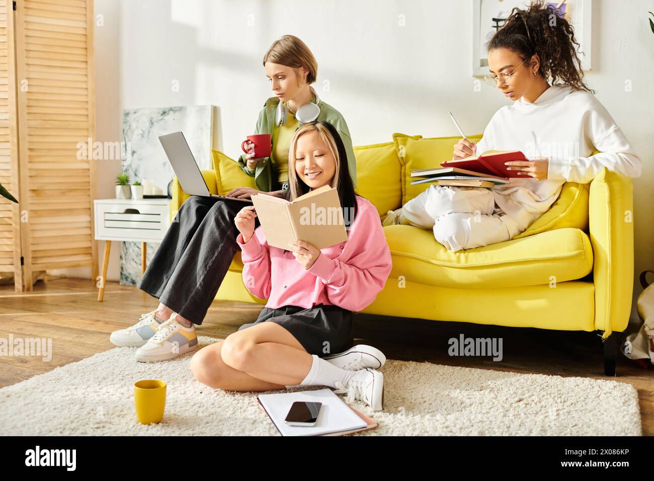 A diverse group of teenage girls sitting closely together on a bright ...