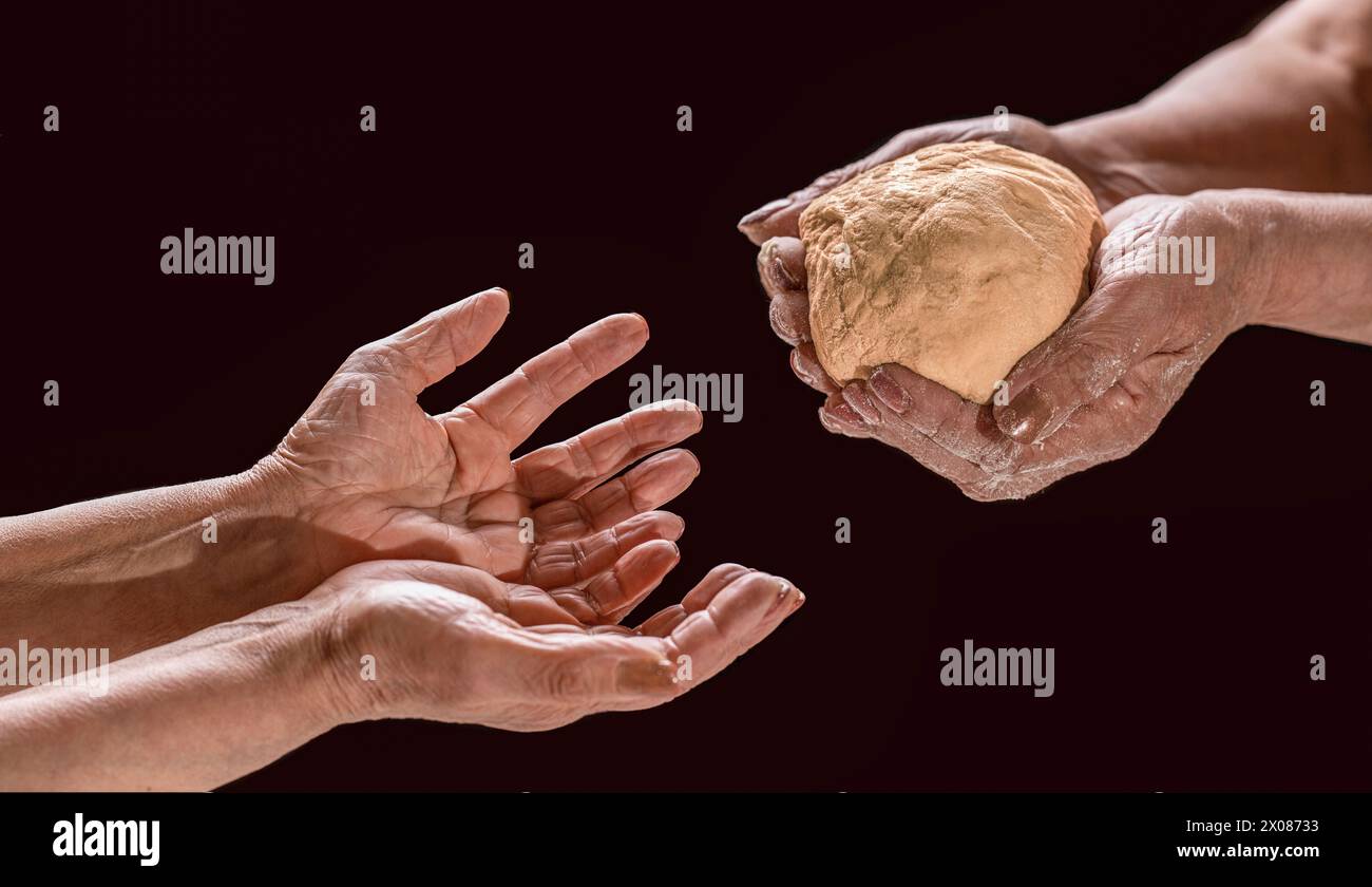 Helping the homeless. Woman giving poor homeless person pieces of bread ...