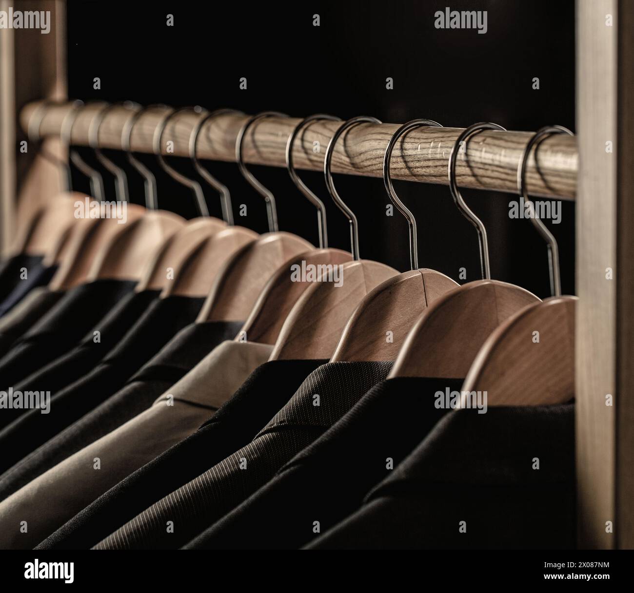 Different women's office classic jackets hang on a hanger for storing ...