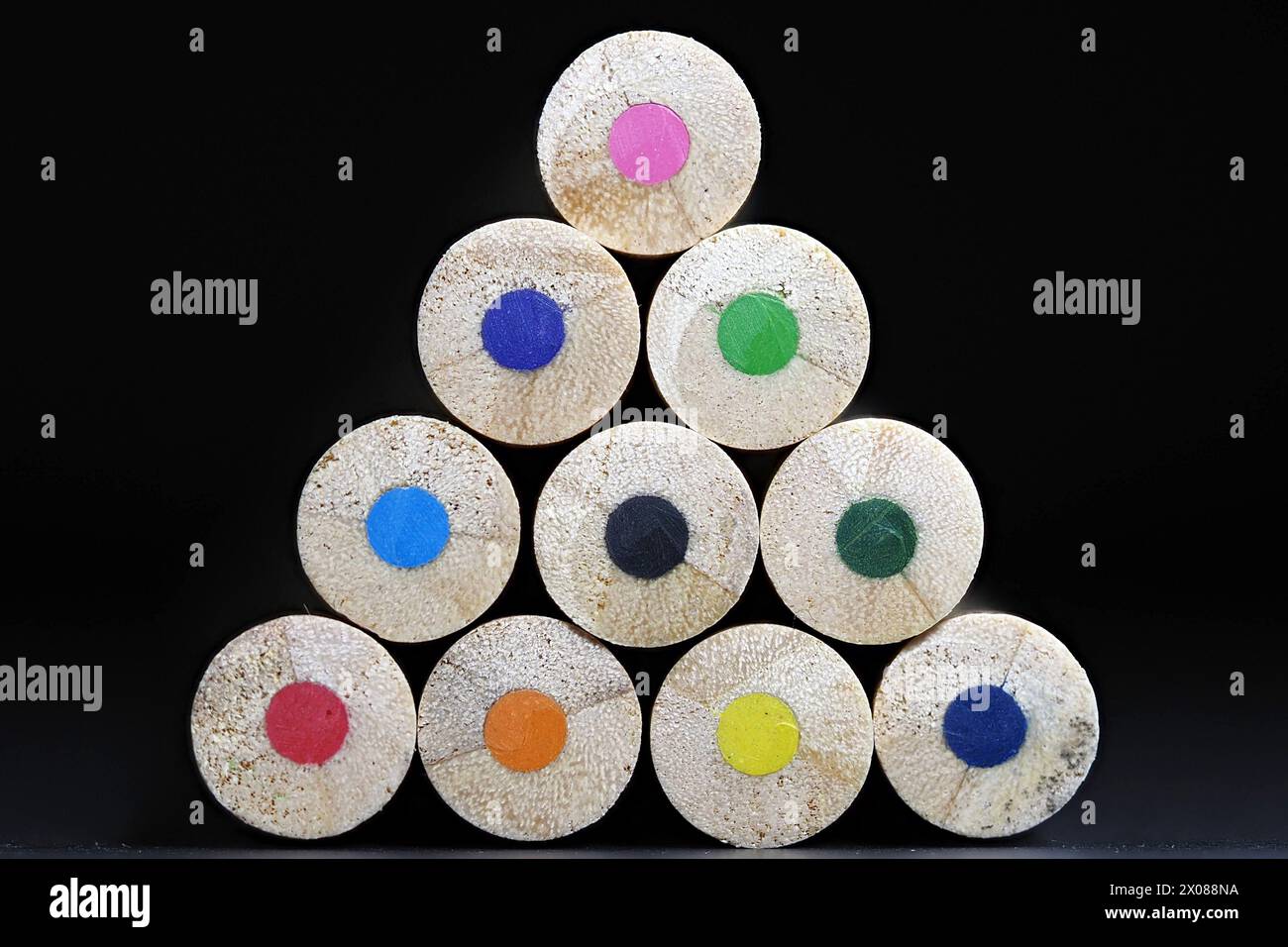 A close-up image of wooden colouring pencils stacked in the shape of a ...