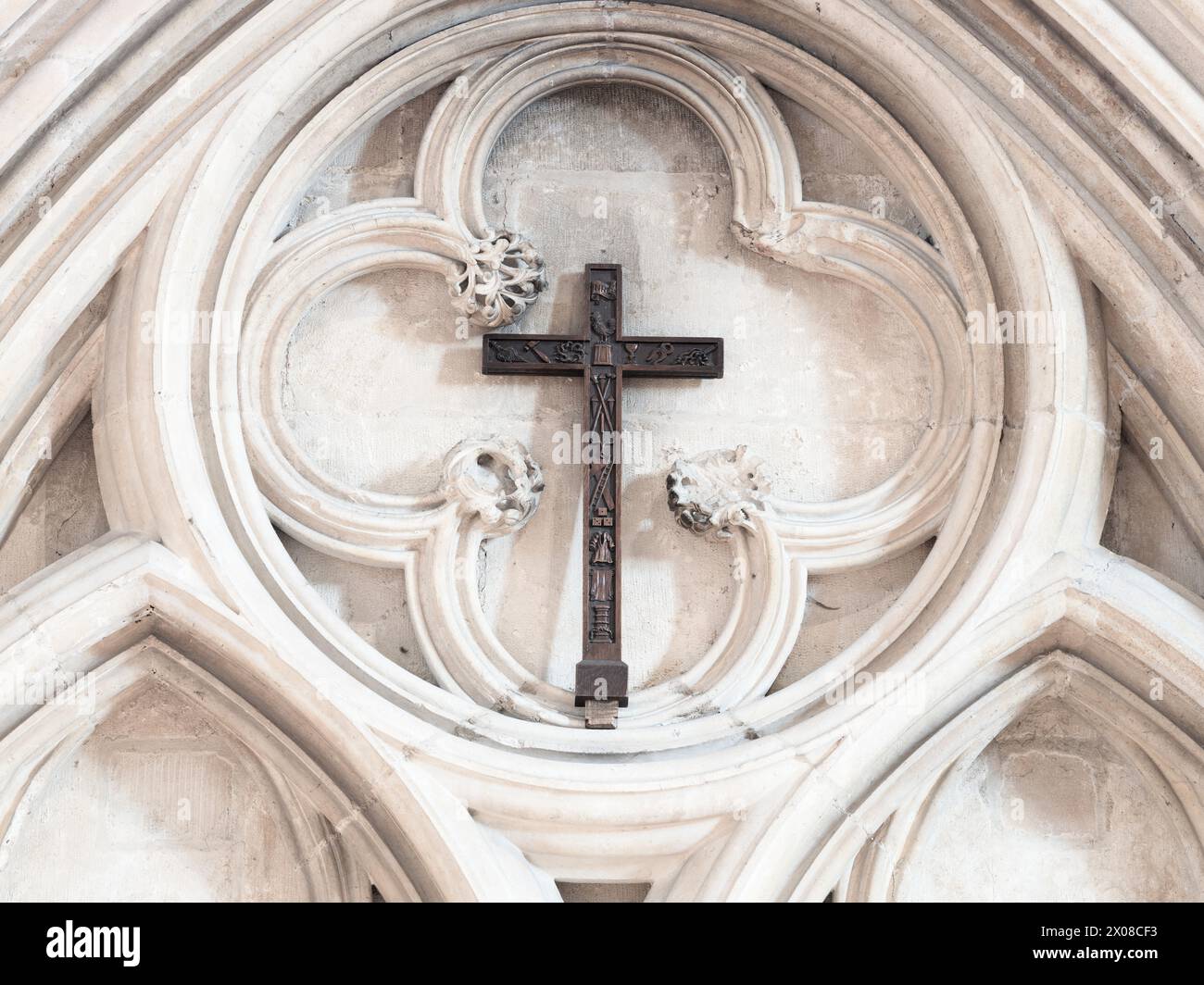 Wooden cross on the decorated wall behind the altar in the east end of ...