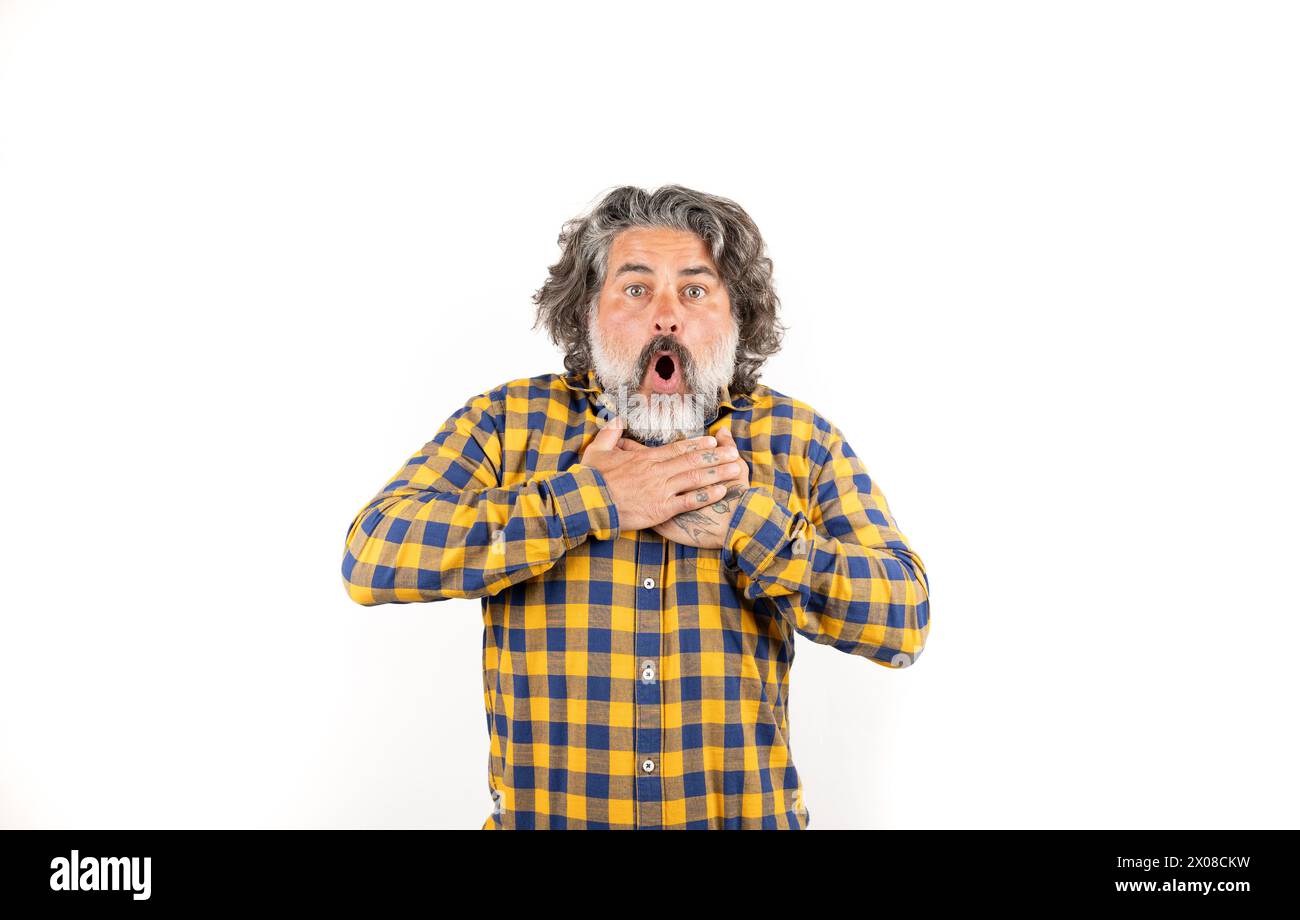 A man with his hands on his chest catching air on a white background ...