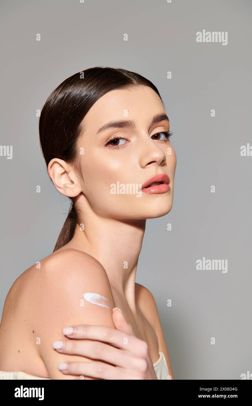 A brunette woman with cream smeared all over her face, embodying a ...