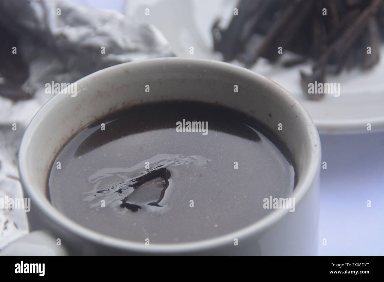 hot chocolate drink in a white cup. Its thick texture is drunk when it ...