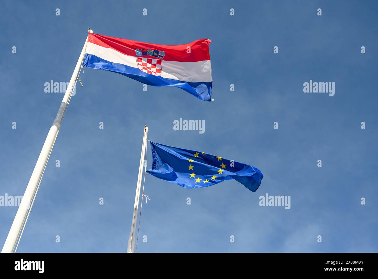 Croatian and EU flag waving in the wind. Flags of Croatia and European ...