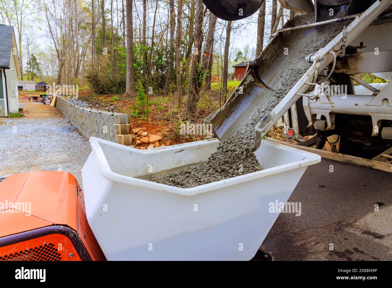 Construction site displays wet cement coming out of cement truck chute ...