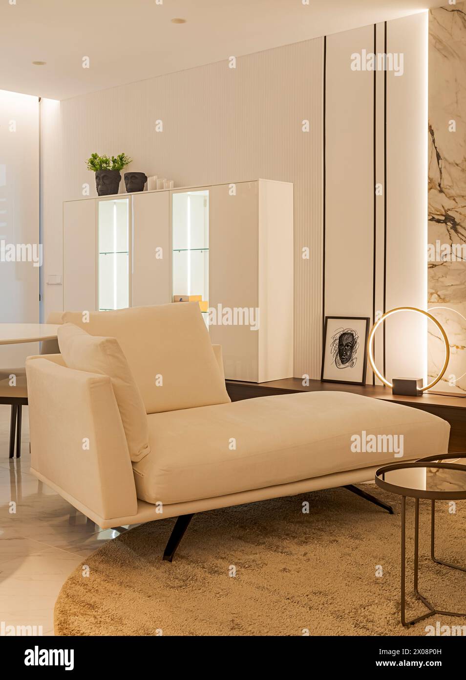 Contemporary living room featuring a beige sofa, marble walls, and ...