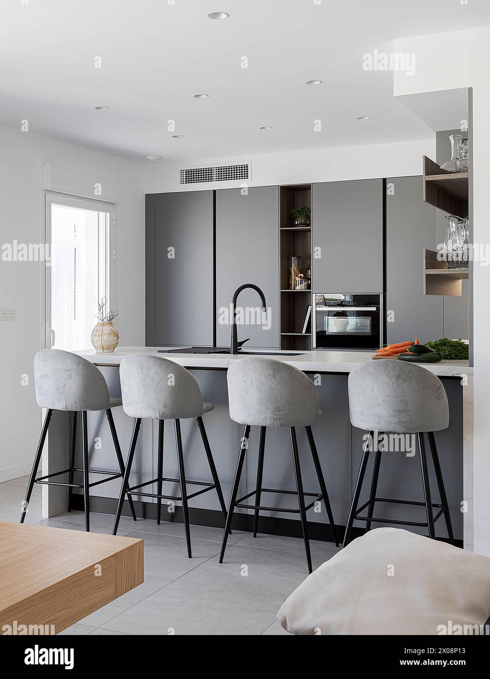 Contemporary kitchen space featuring a sleek breakfast bar with stylish ...